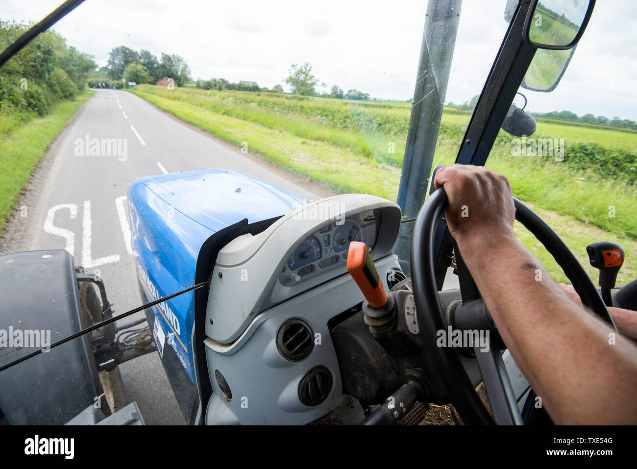 Tractor being driven though Rural Leicestershire, England UK Stock ...