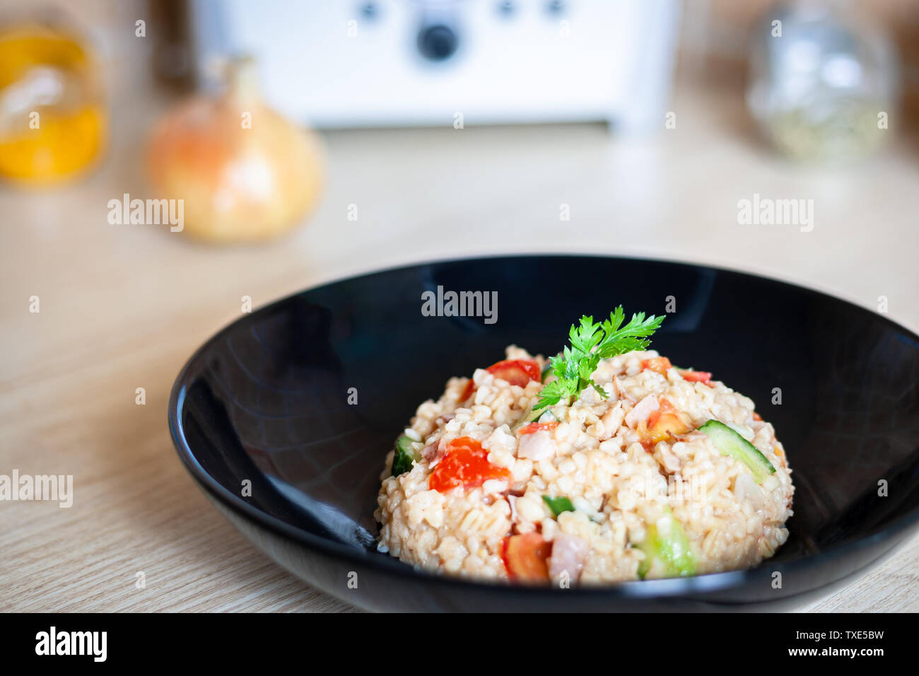 Bulgur salad with vegetables on the kitchen table with ingredients ...