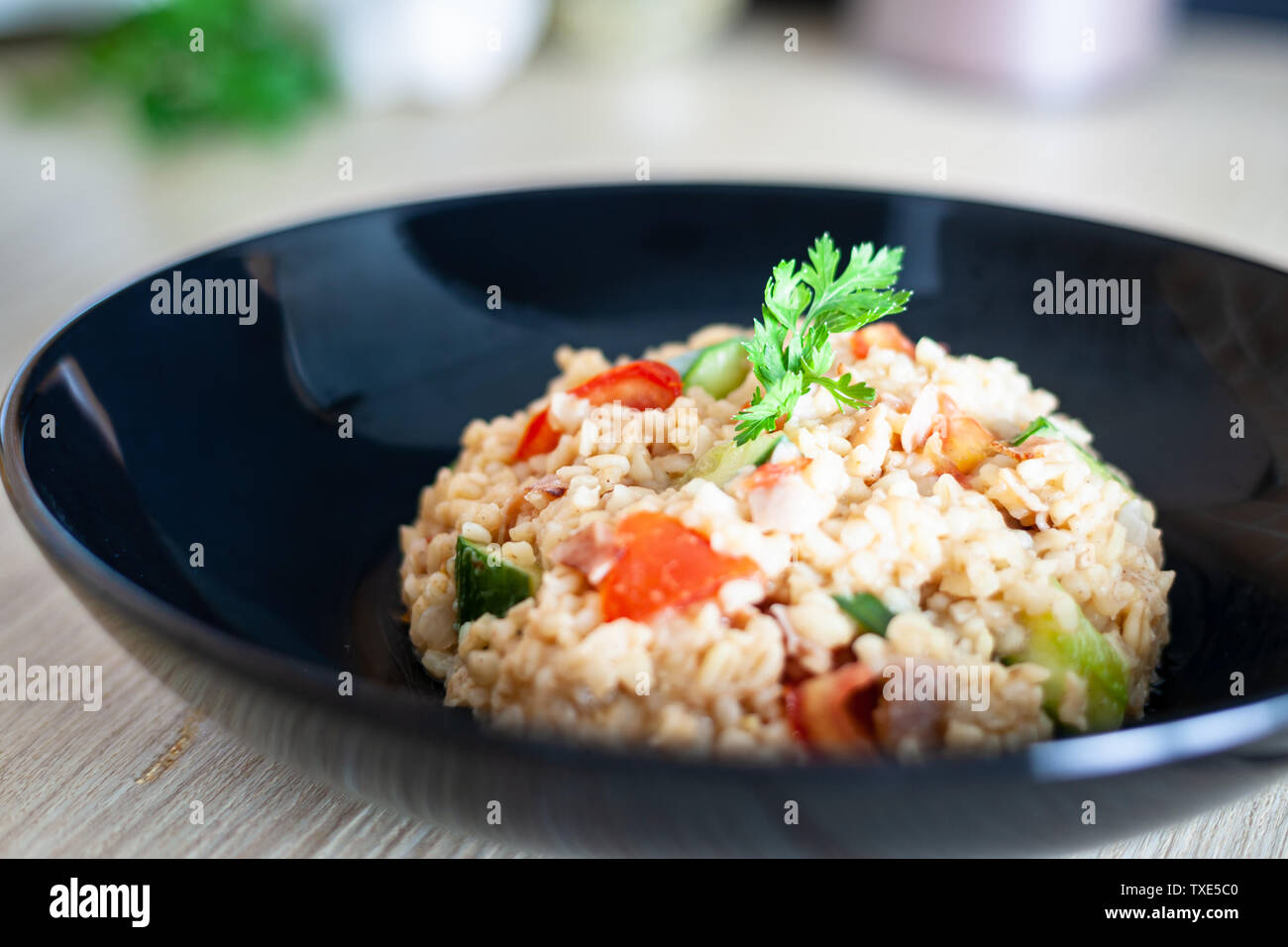 Bulgur salad with vegetables on the kitchen table with ingredients ...