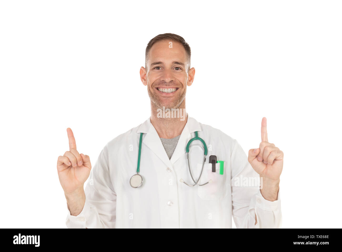 Young doctor pointing something with his finger isolated on a white ...