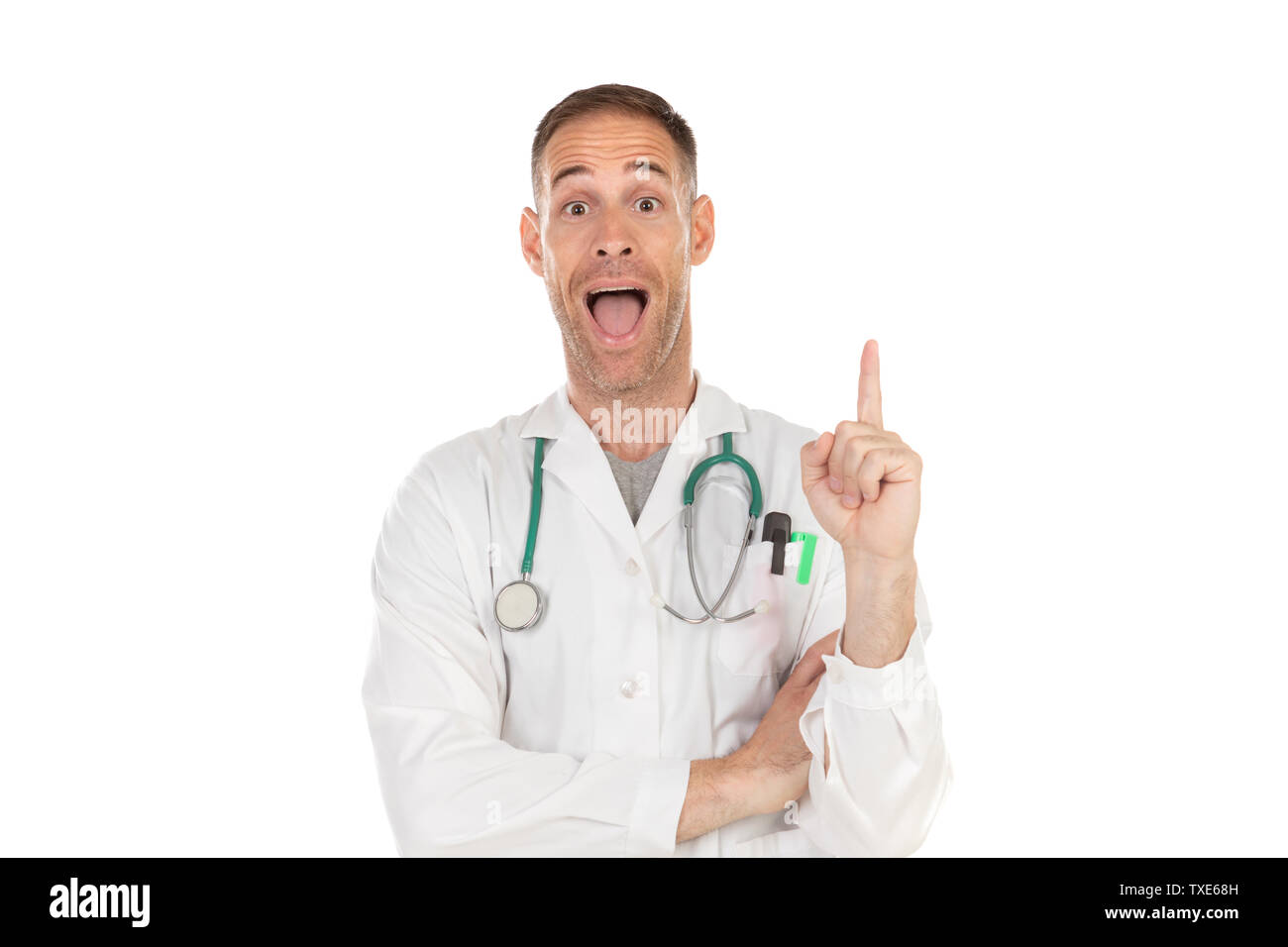 Surprised doctor pointing something with his finger isolated on a white ...