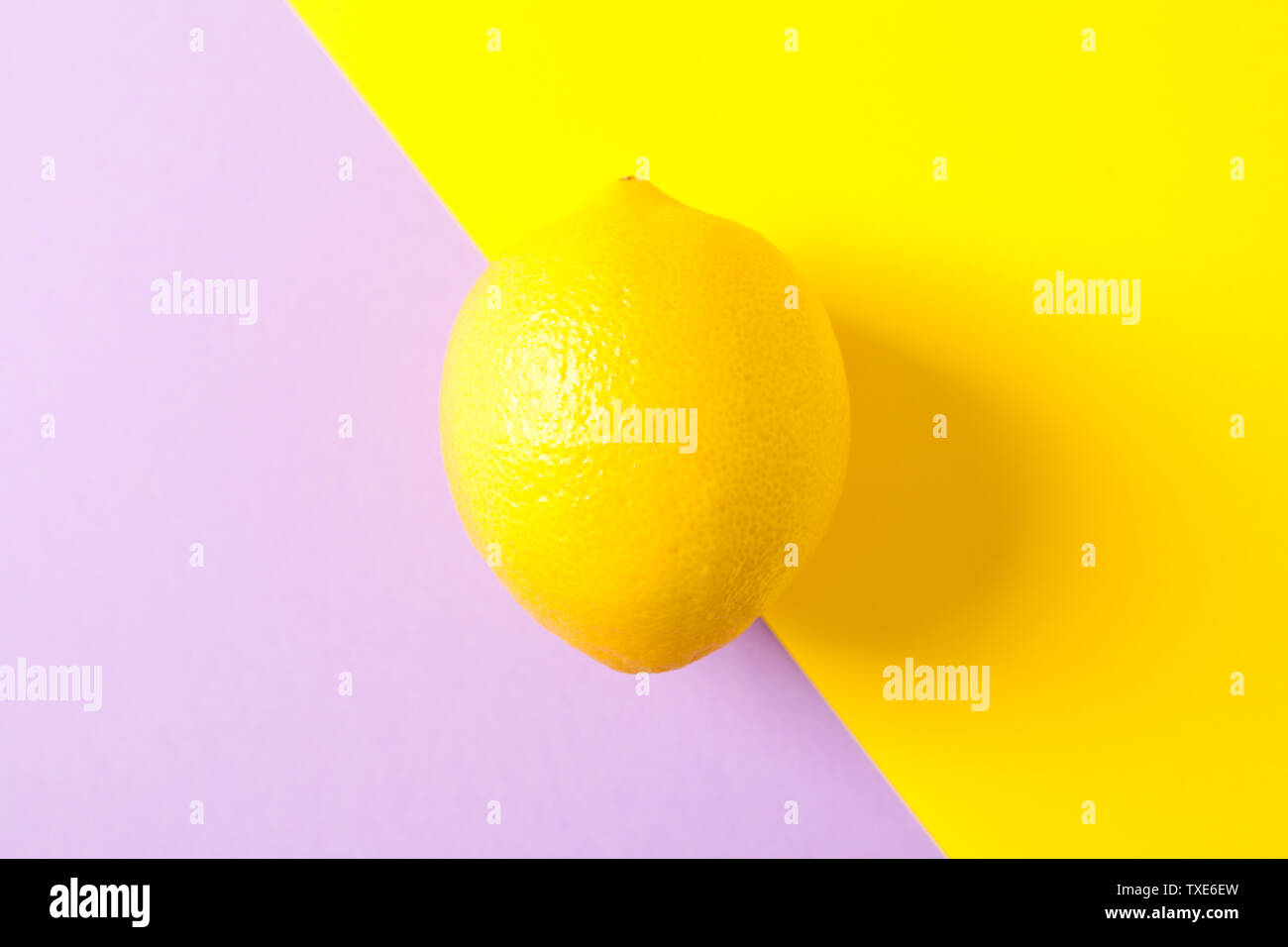 Fresh lemon on two tone background, space for text Stock Photo - Alamy