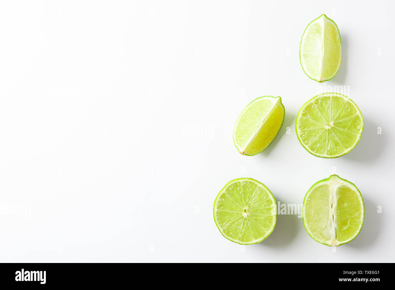 Flat lay composition with limes on white background, space for text ...