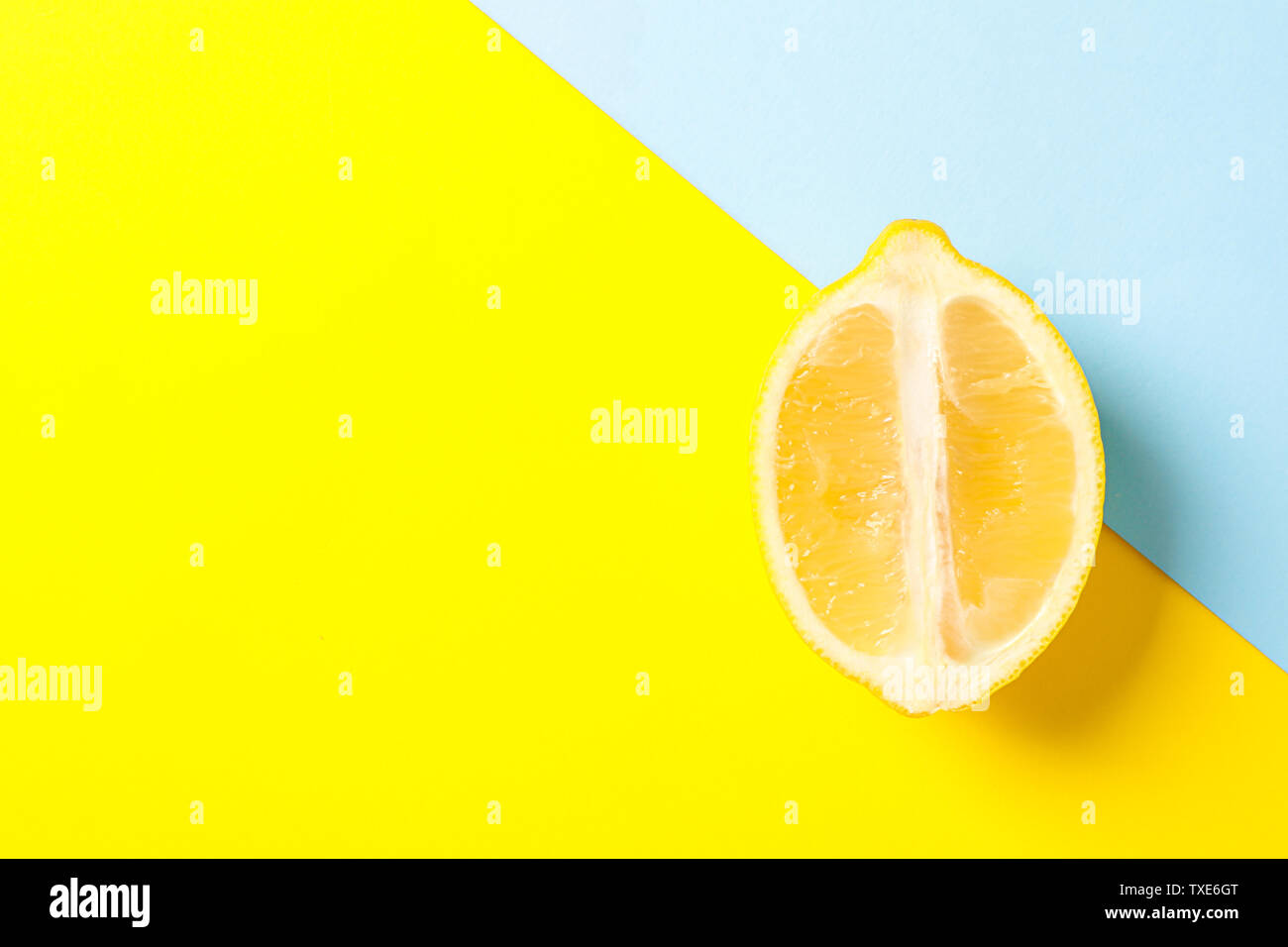 Fresh lemon on two tone background, space for text Stock Photo - Alamy