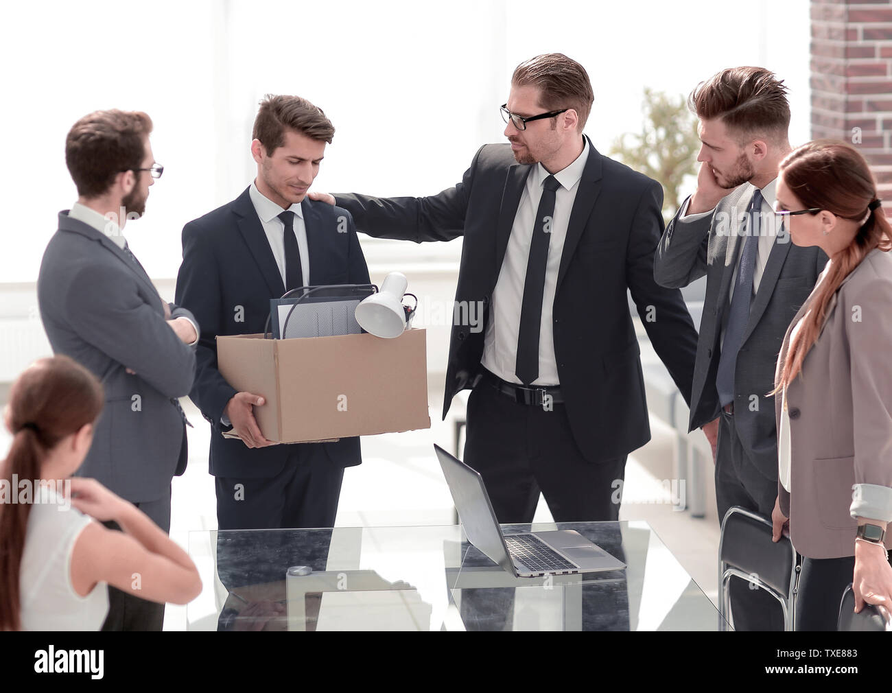 fired employee with personal things saying goodbye to colleagues Stock ...