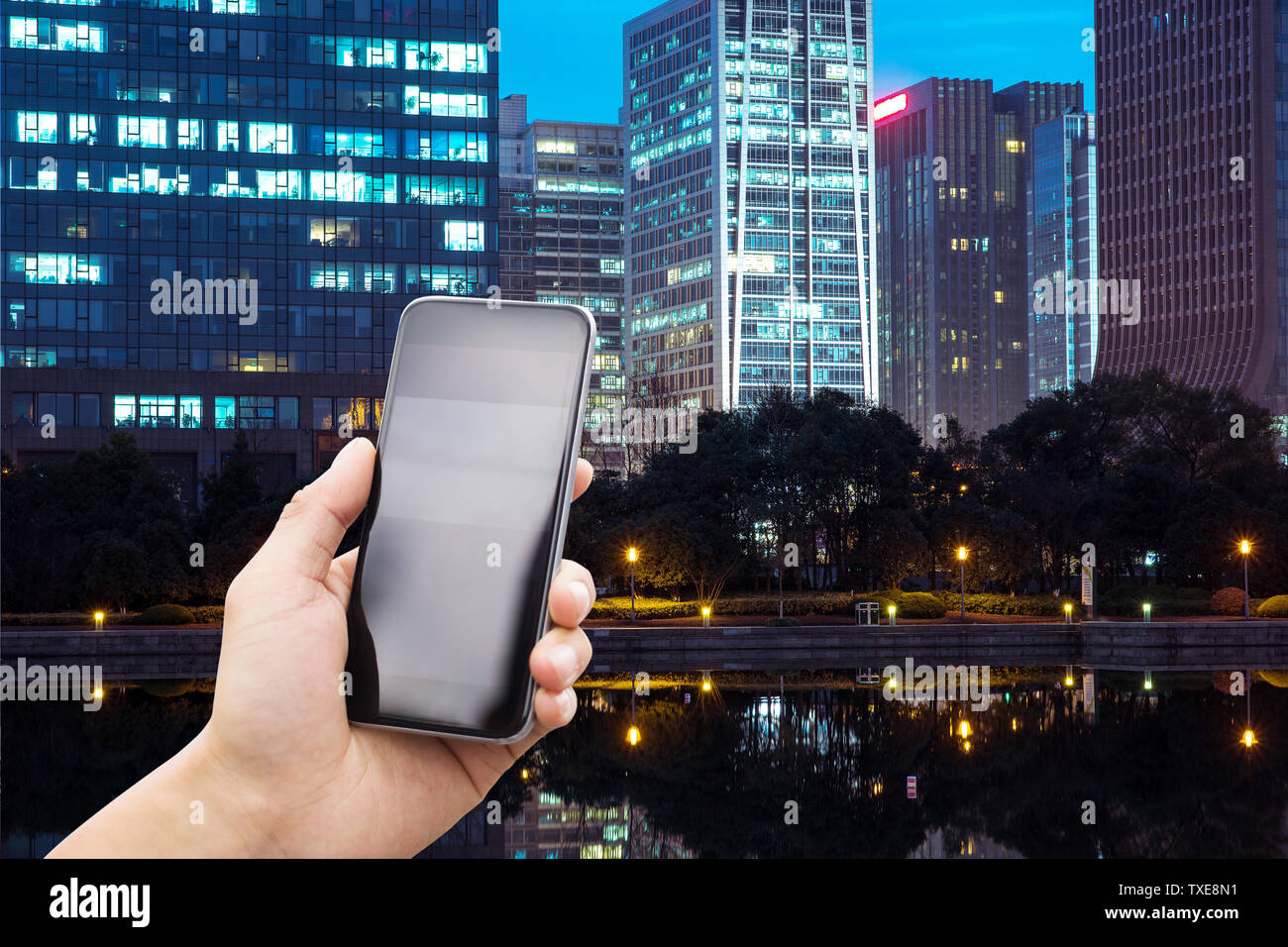 mobile phone with modern buildings at night Stock Photo - Alamy