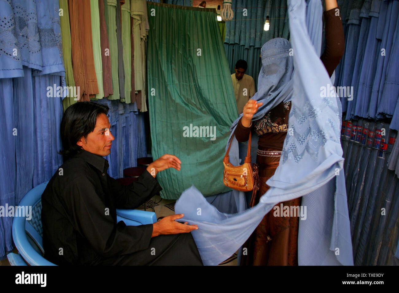 Afghan burqa-clad women shop in Herat, Afghanistan on August 12, 2009 ...