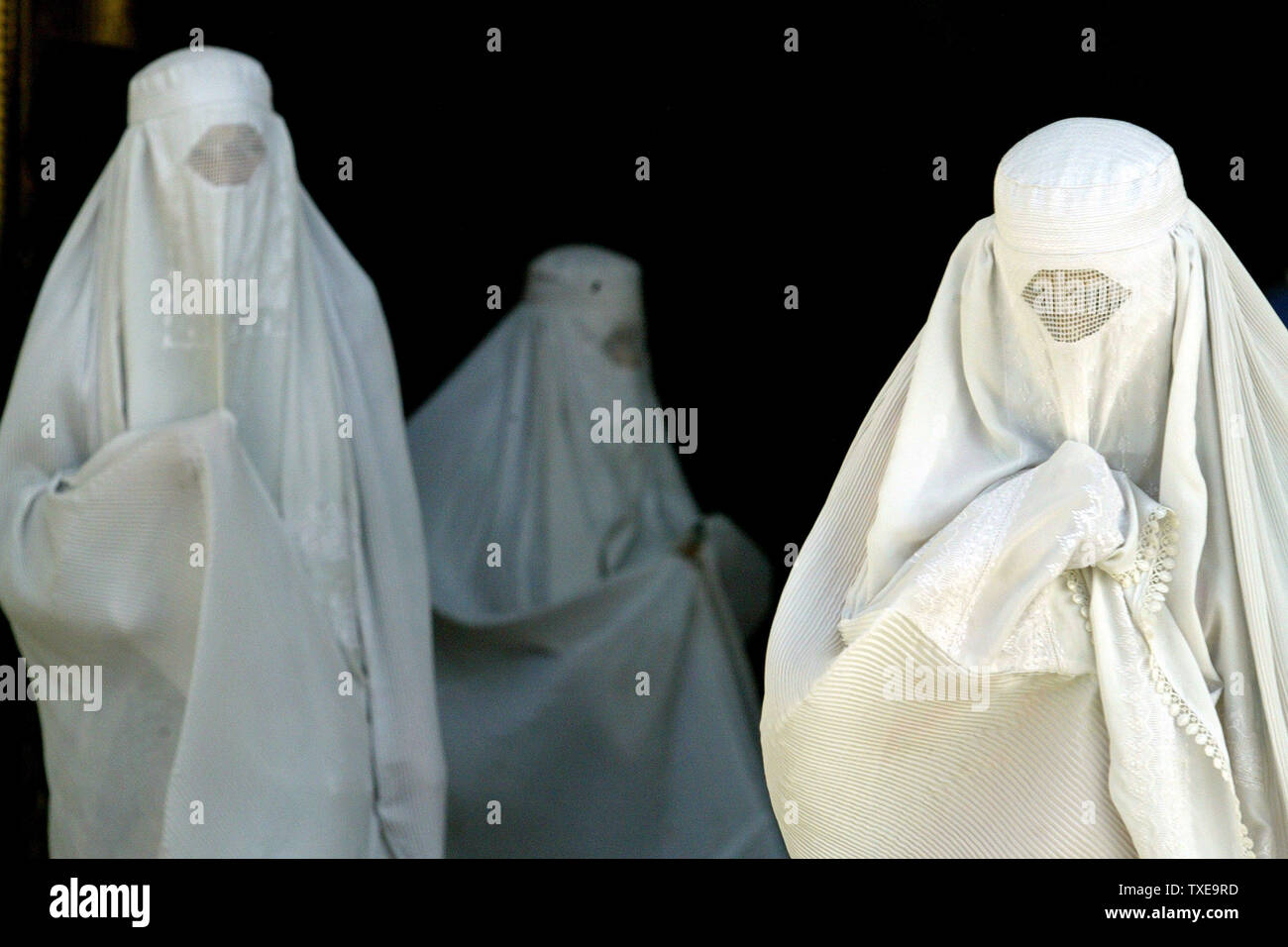 White Burqa-clad women leave the Blue Mosque after their prayers in ...