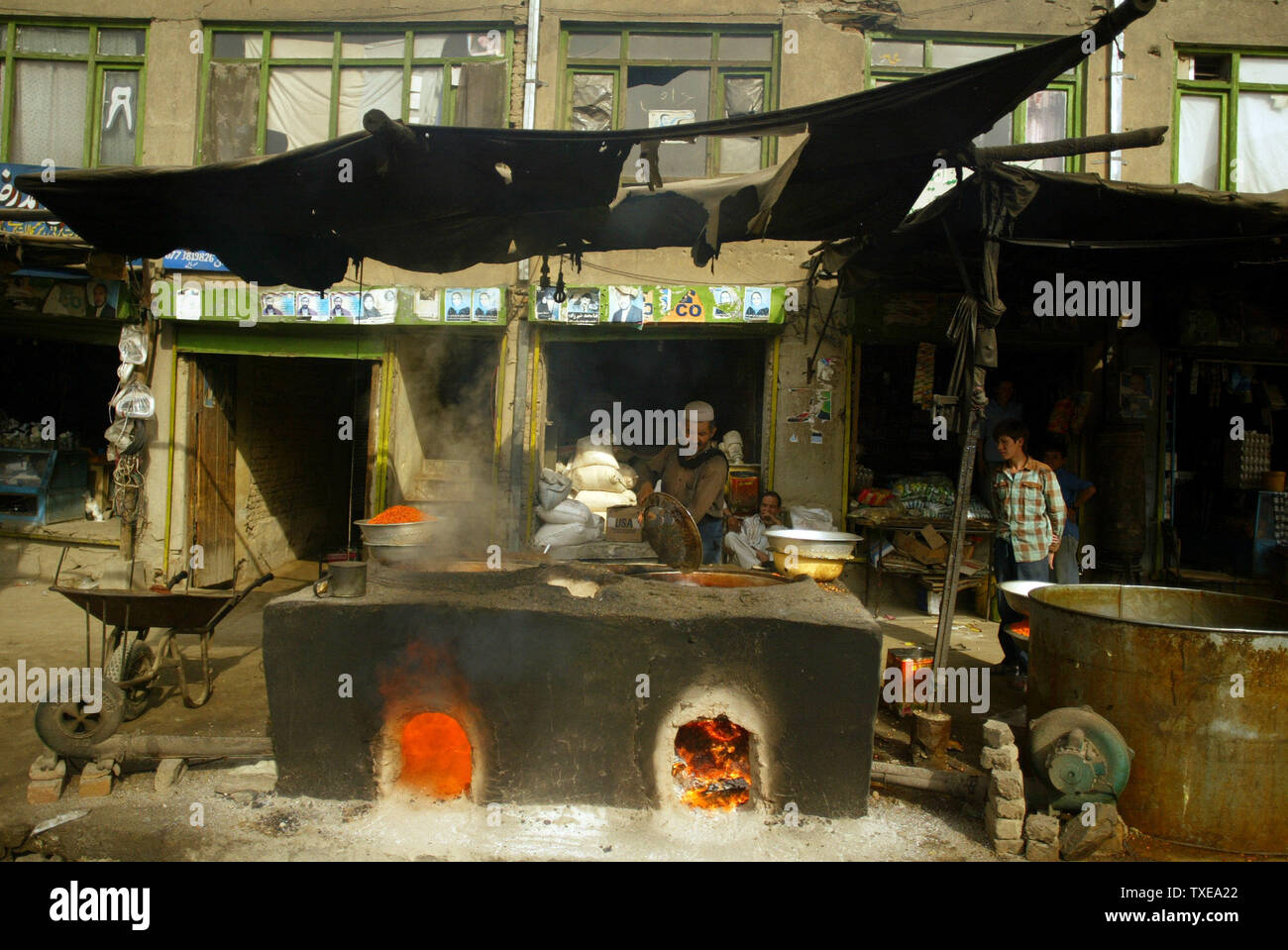 A man makes traditional food in a bazaar in Kabul, Afghanistan on ...