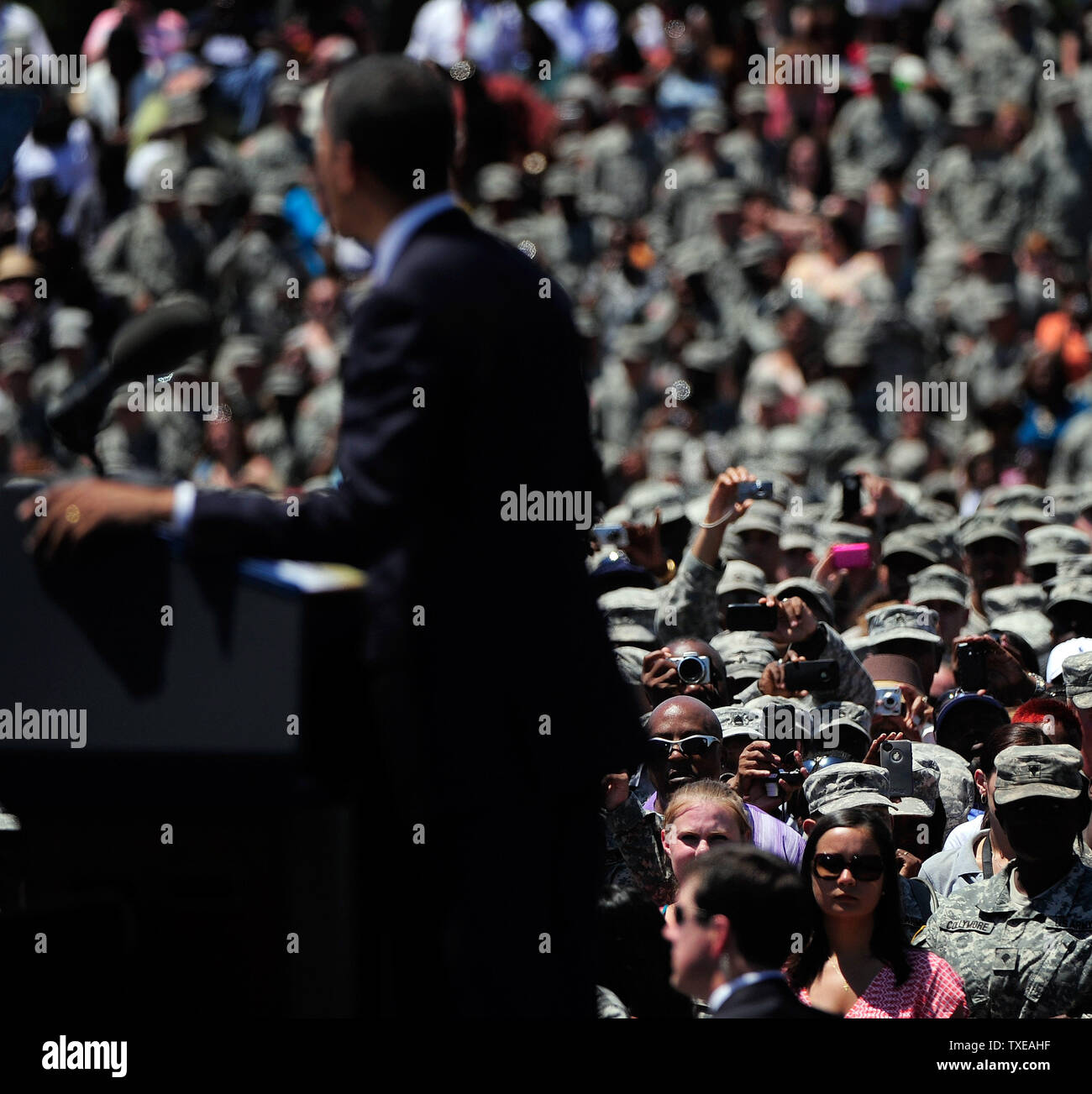 Members of the military take photos of President Barack Obama as he ...