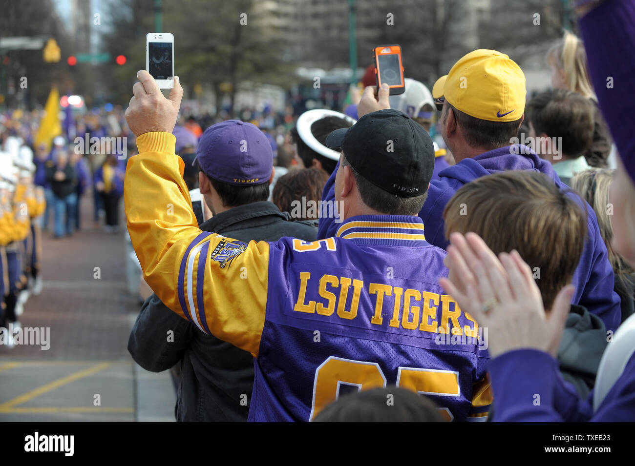 Football fans take pictures as high school bands, drill teams, parade ...