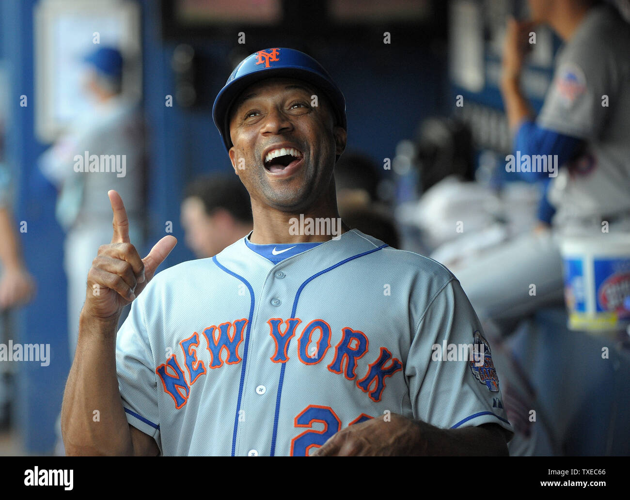 New York Mets first base coach Tom Goodwin jokes around in the dugout ...
