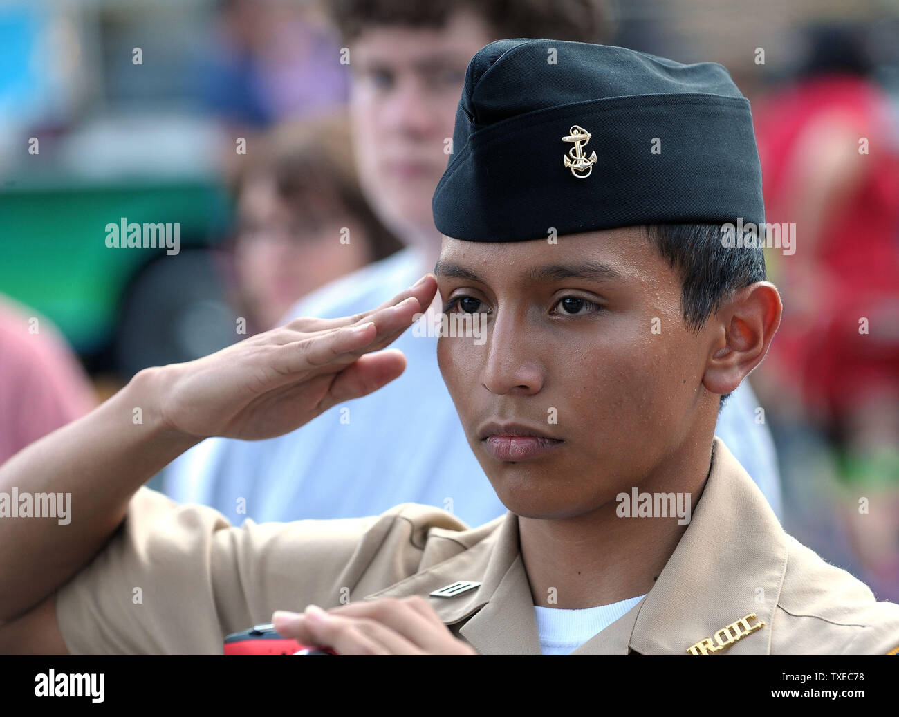 Cross Keys High School ROTC cadet Lucas Ruiz salutes the US flag as he ...