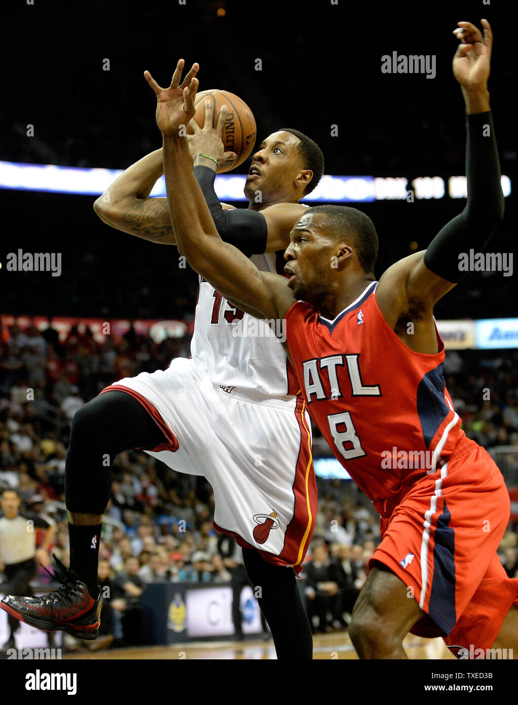 Miami Heat guard Mario Chalmers (15) is fouled by Atlanta Hawks ...