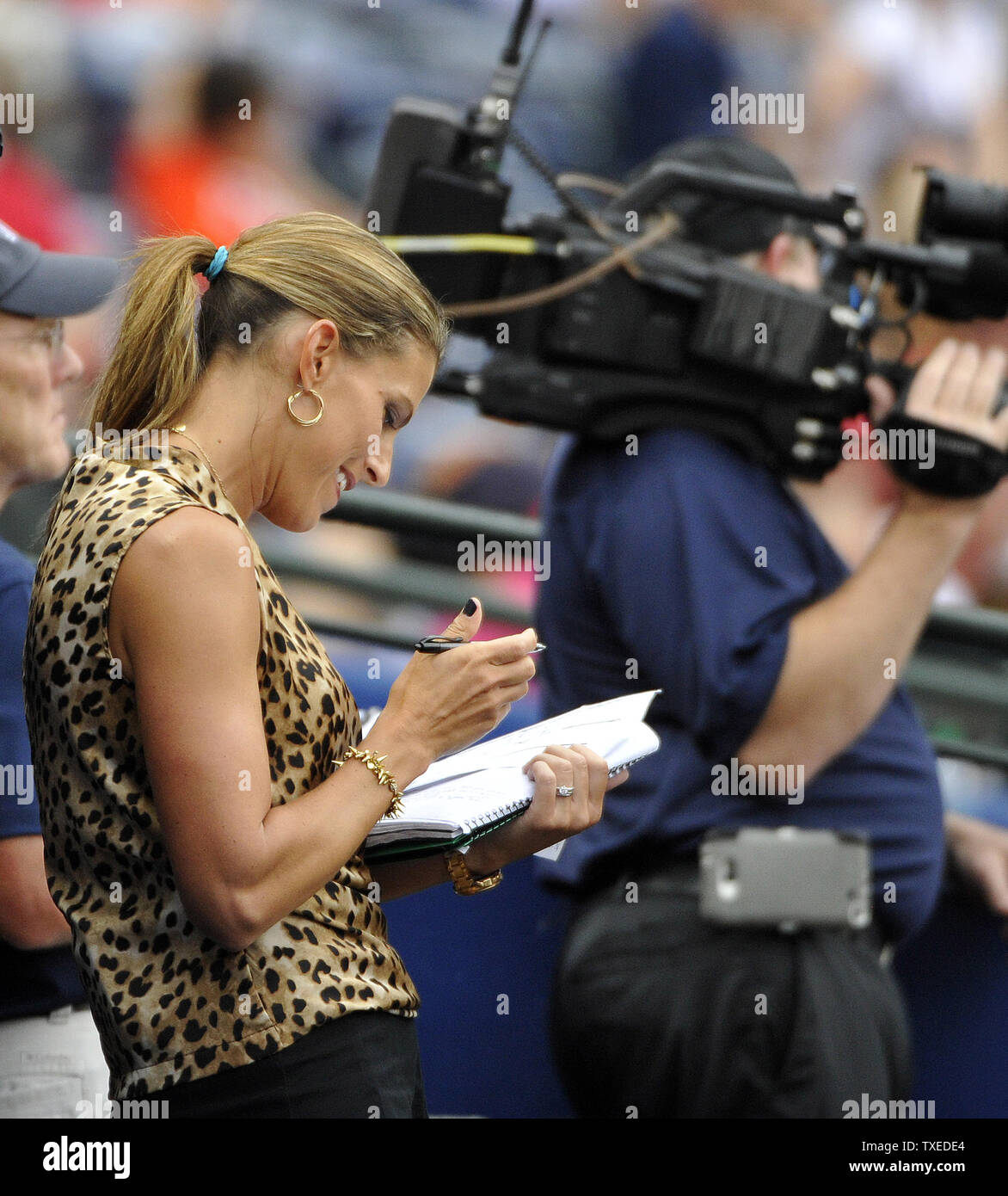 Fox Sports reporter Jenn Hildreth smiles as she takes notes during the ...