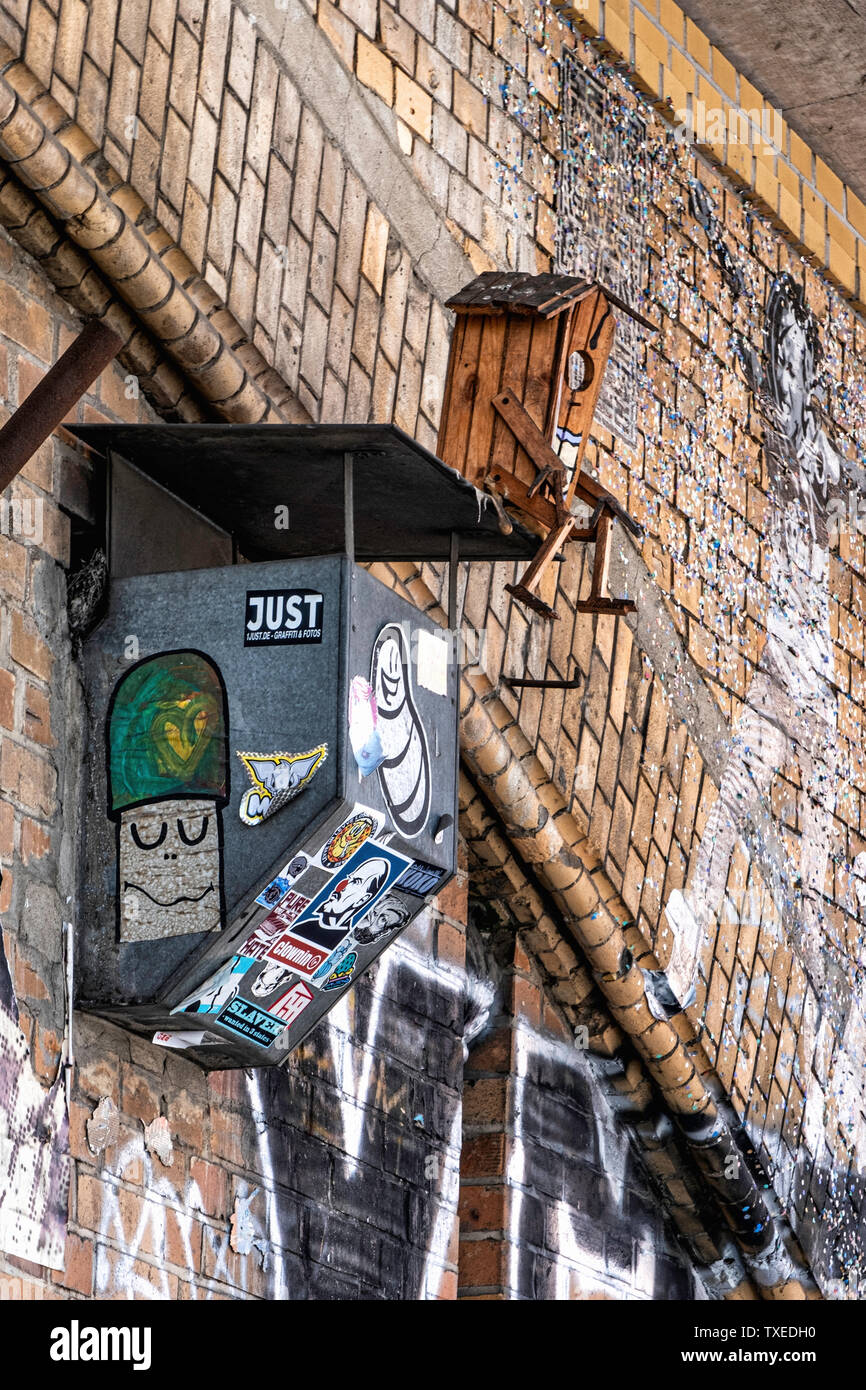 Street art and unusual bird nesting box on brick railway viaduct in ...