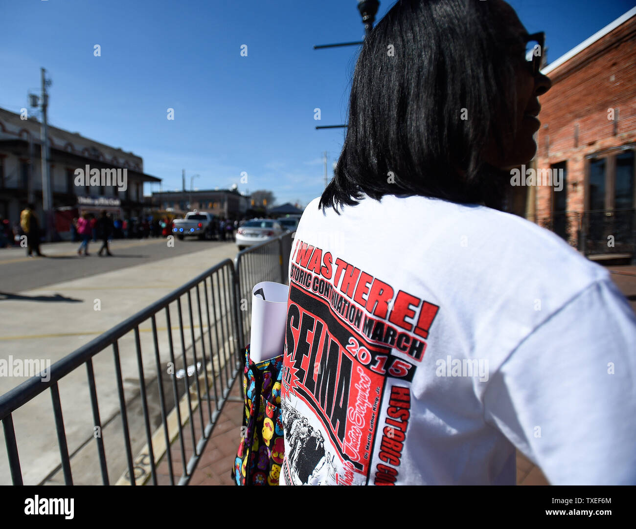 A woman wears a souvenir t-shirt during events remembering the violent ...