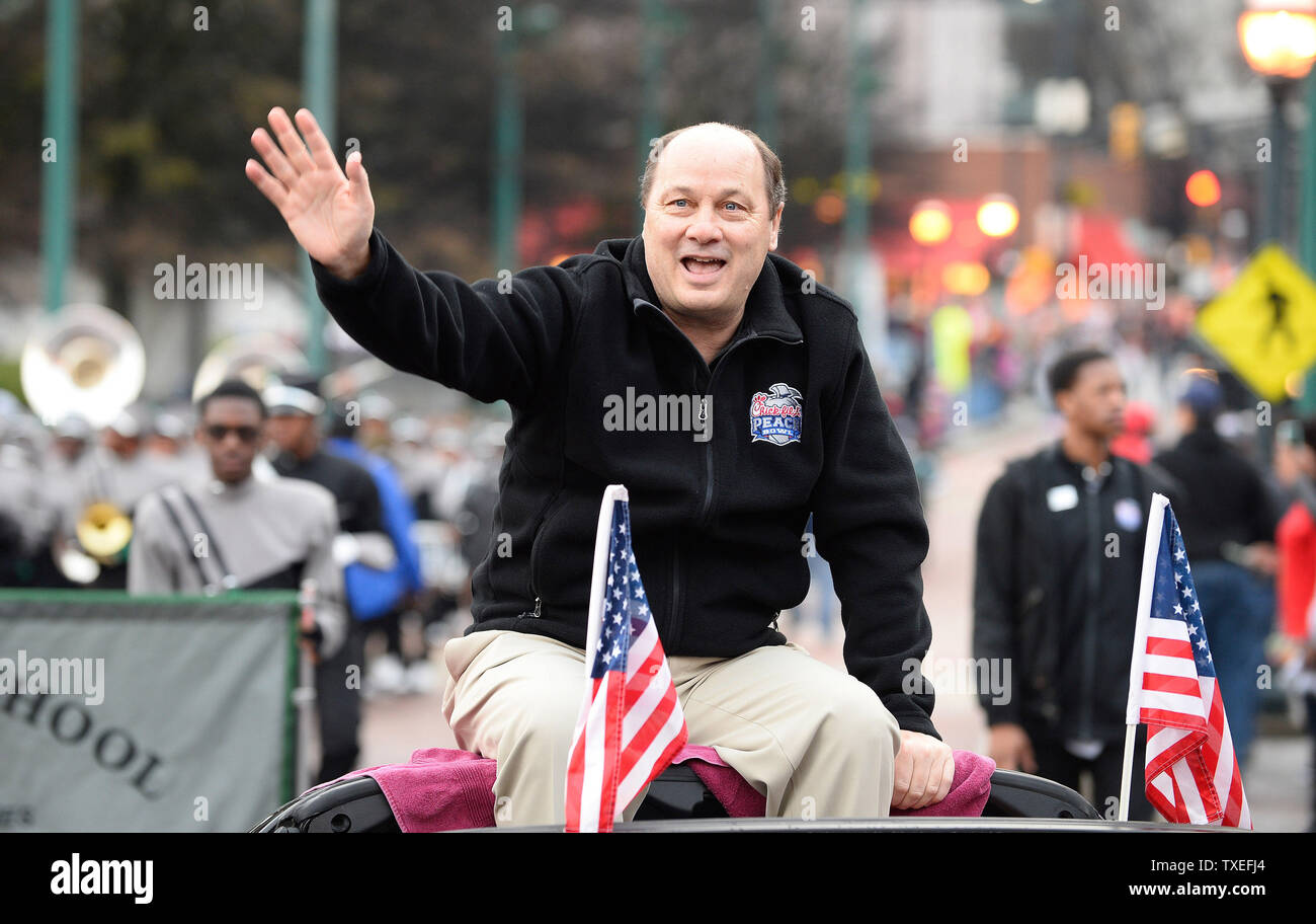 Chick-fil-A Peach Bowl CEO Gary Stokan waves as he makes his way down ...