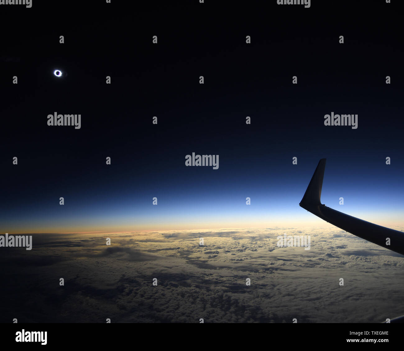 A total solar eclipse is viewed while flying on board a special flight ...