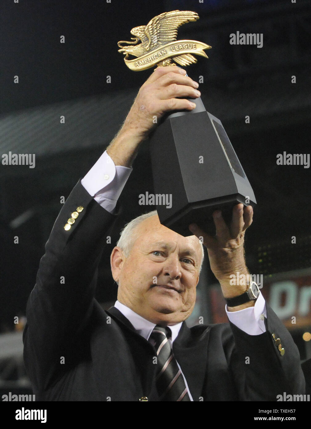 Texas Rangers team owner Nolan Ryan holds the ALCS champion trophy ...