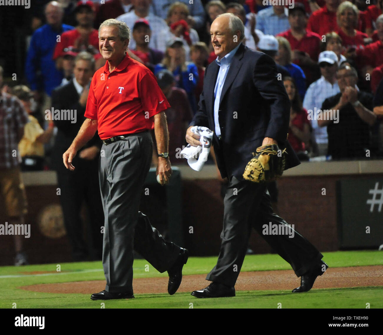 Former President George Bush (L) and Nolan Ryan leave the fieldafter ...