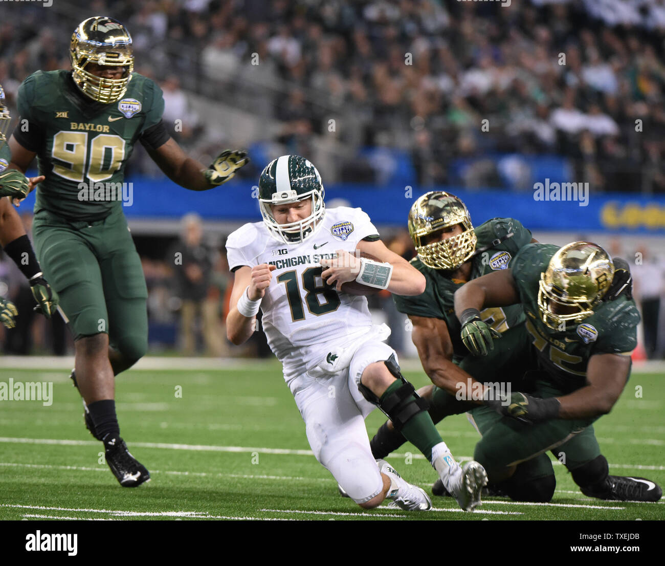 Michigan State quarterback Connor Cook slides between Baylor Bears ...