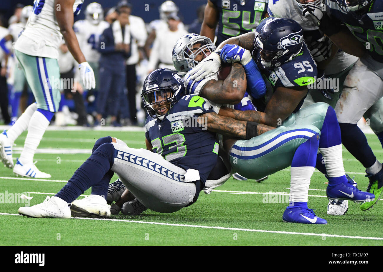 Dallas Cowboys Ezekiel Elliott gets sandwiched between Seattle Seahawks ...