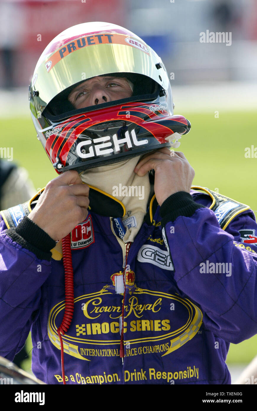Grand American Road Racing driver Scott Pruett buckles his helmet ...