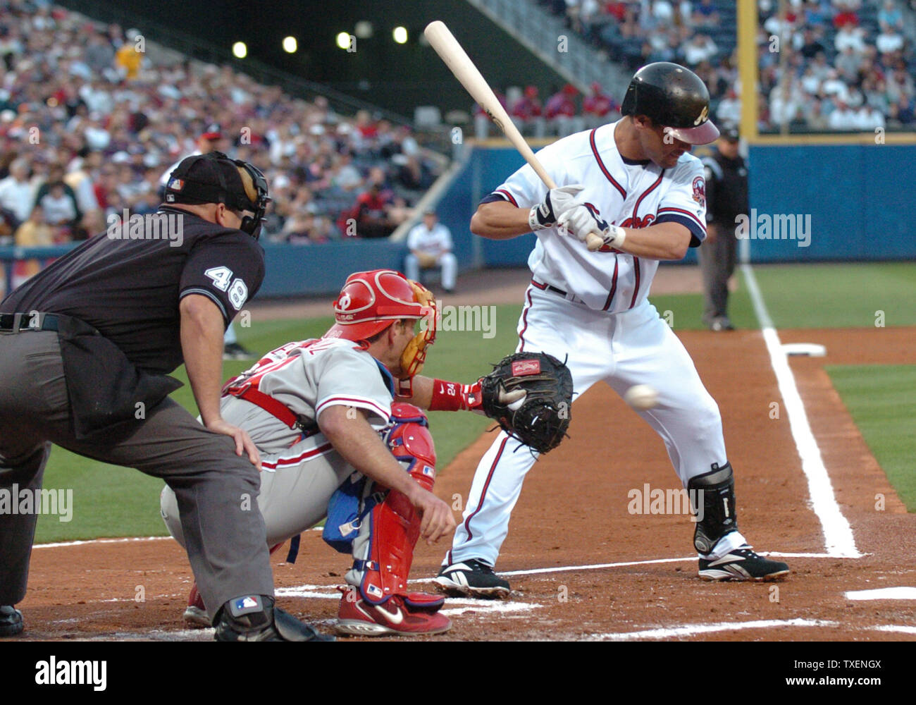 Atlanta Braves Marcus Giles watches as a pitch heads for the glove of ...