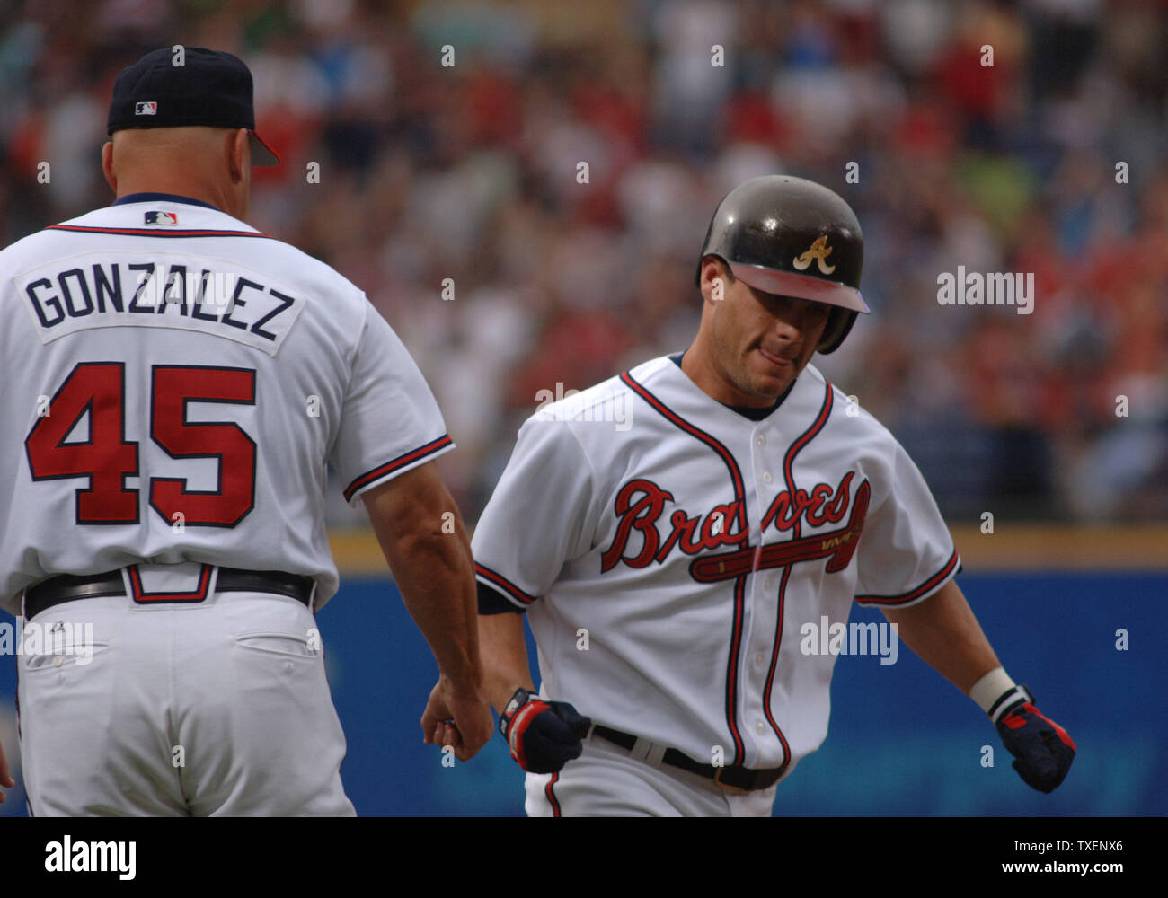 Atlanta Braves Marcus Giles gets kudos from the Braves third base coach ...
