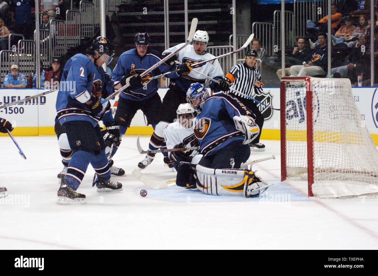 Atlanta Thrashers and Washington Capitals players crowd around the puck ...