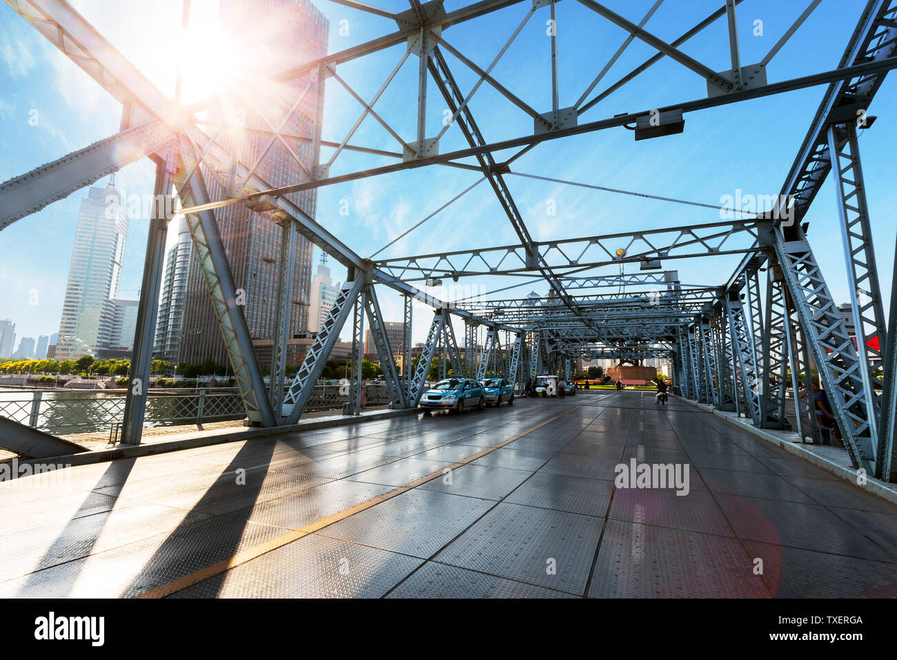 Traffic on steel bridge interior and skyline at sunset Stock Photo - Alamy