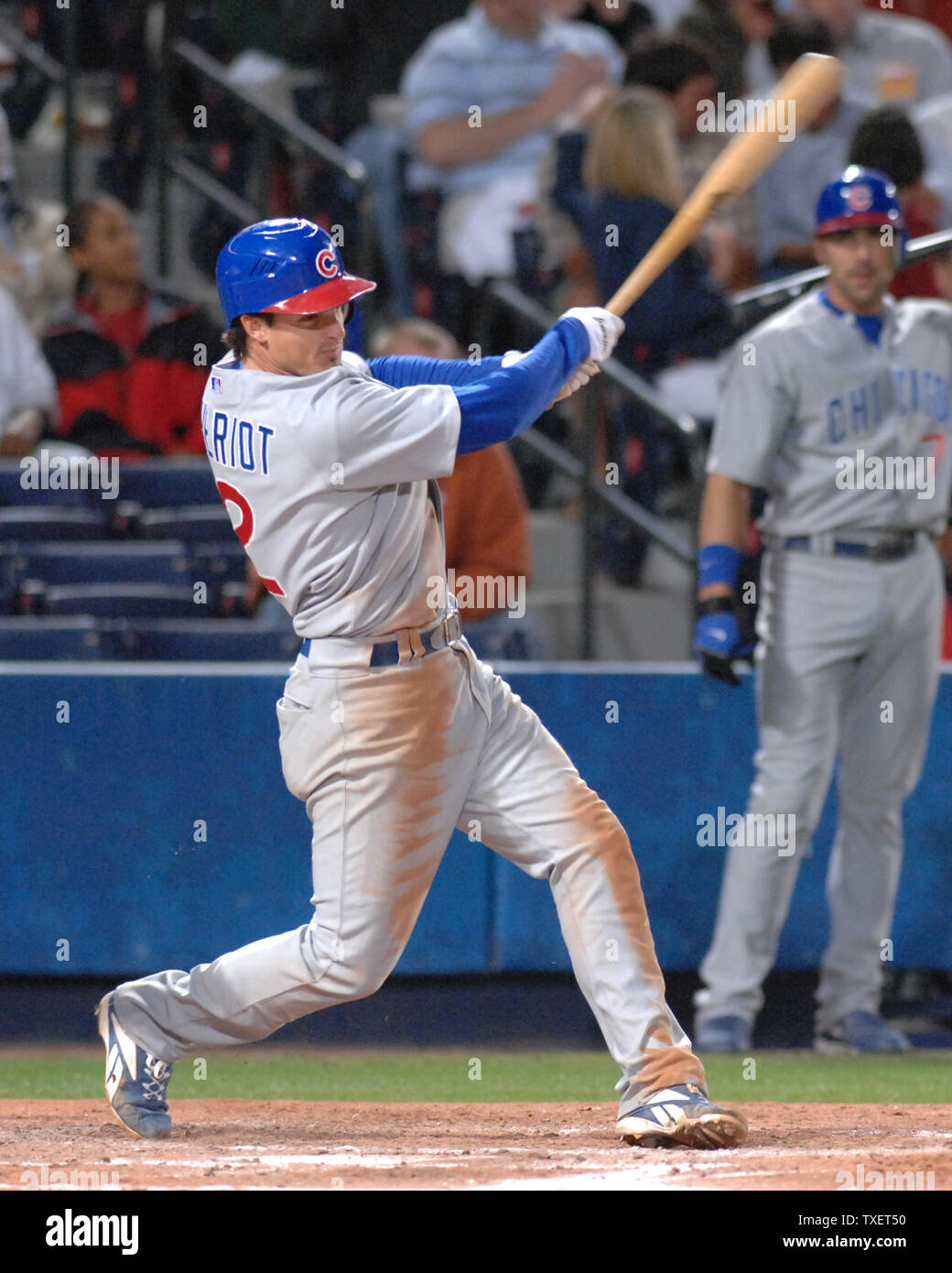 Chicago Cubs Ryan Theriot hits a single against the Atlanta Braves in ...