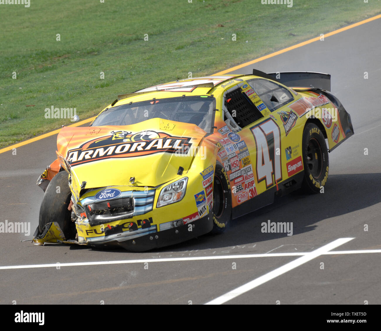 Jon Wood, in the Armor All Ford, limps into the pits after hitting the ...