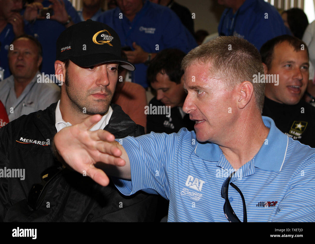 Jeff Burton (R) and Paul Menard attend the drivers meeting prior to the ...