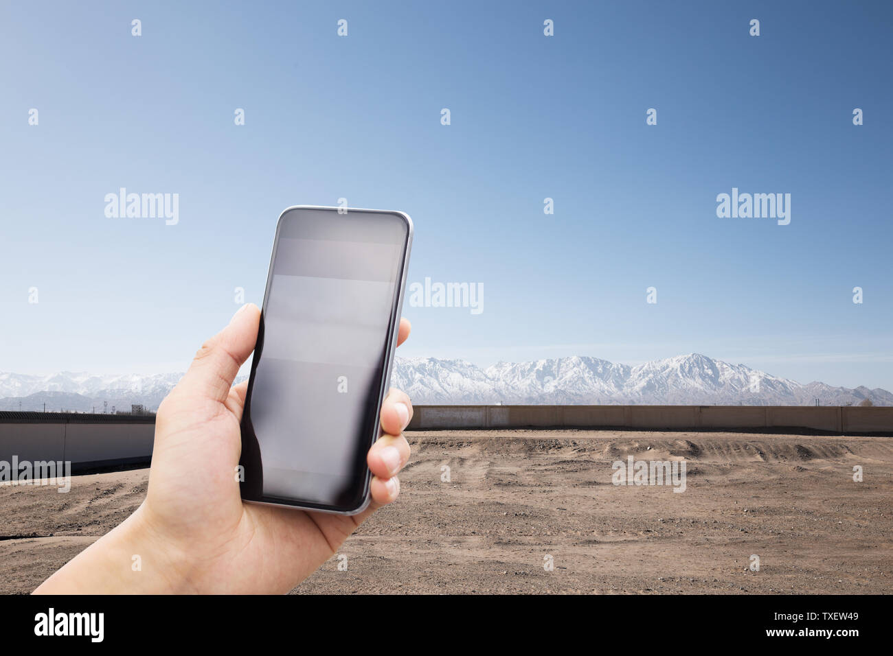 Mobile phone with snow mountain Stock Photo - Alamy
