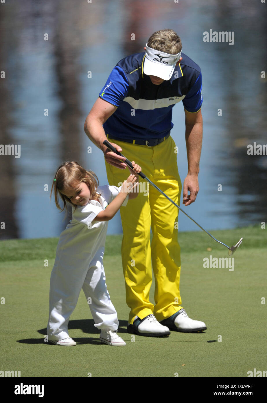 Luke Donald tries to have his daughter Sophia hold a putter during the ...
