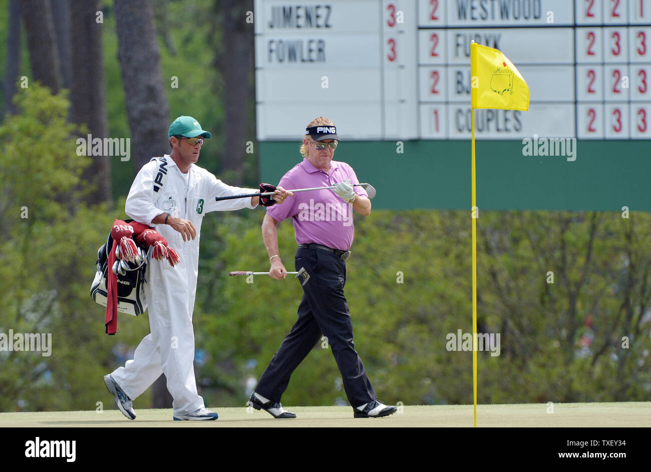 Miguel Angel Jimenez and caddie Clifford Botha walk off of the 3rd ...