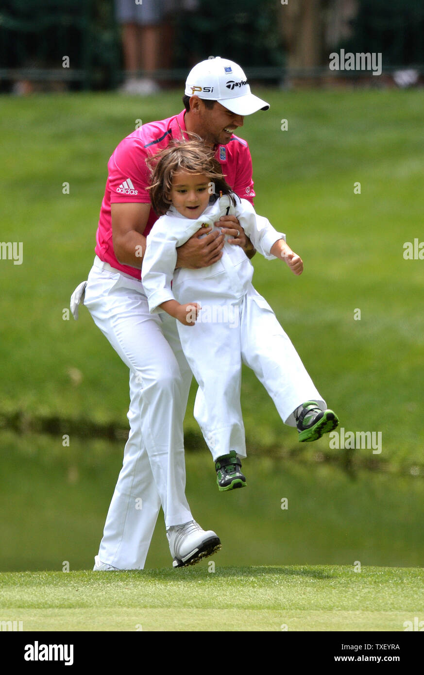 Jason Day holds his son Dash during the Par Three Contest at the 2016 ...