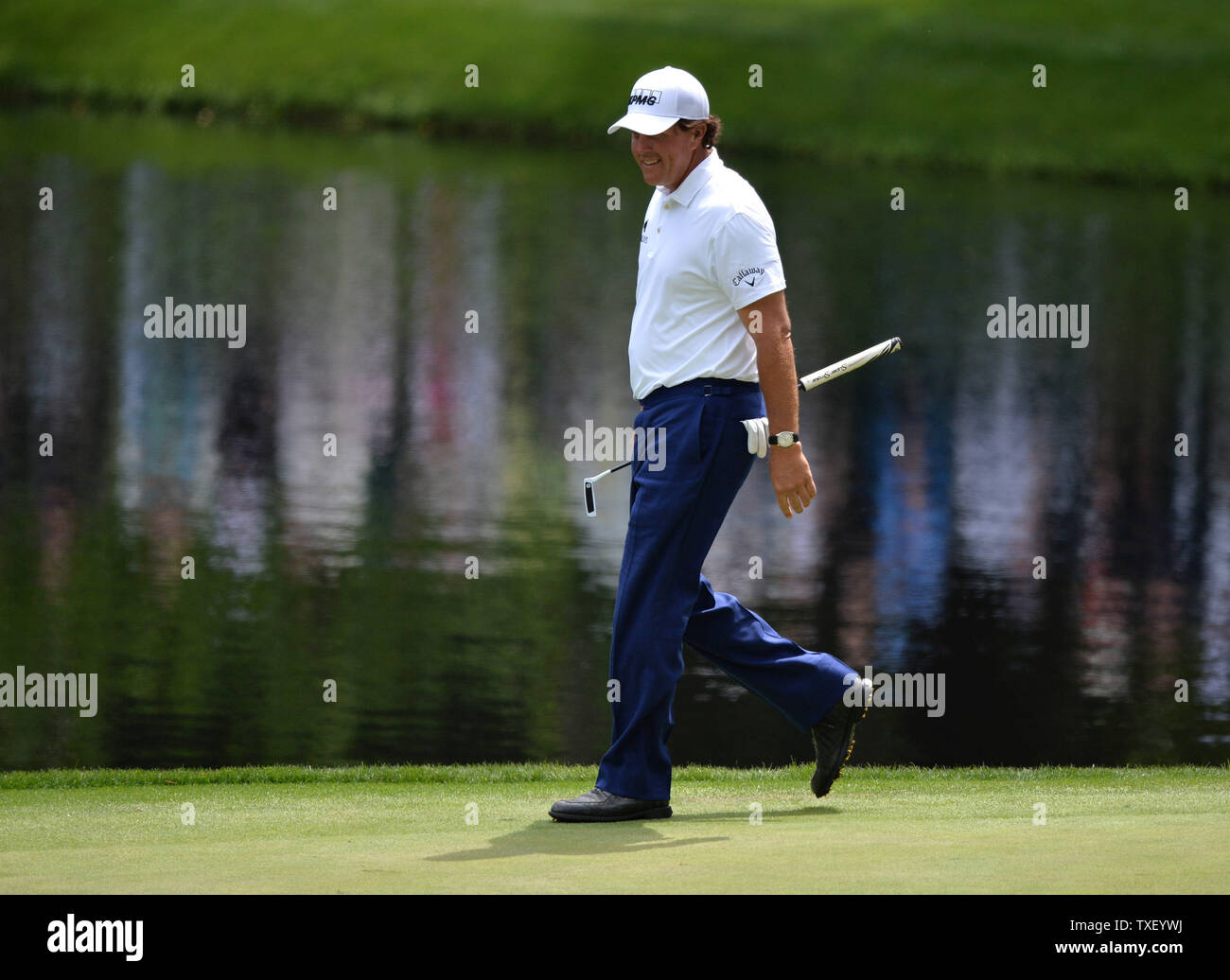 Phil Mickelson walks onto the ninth green during the Par Three Contest ...