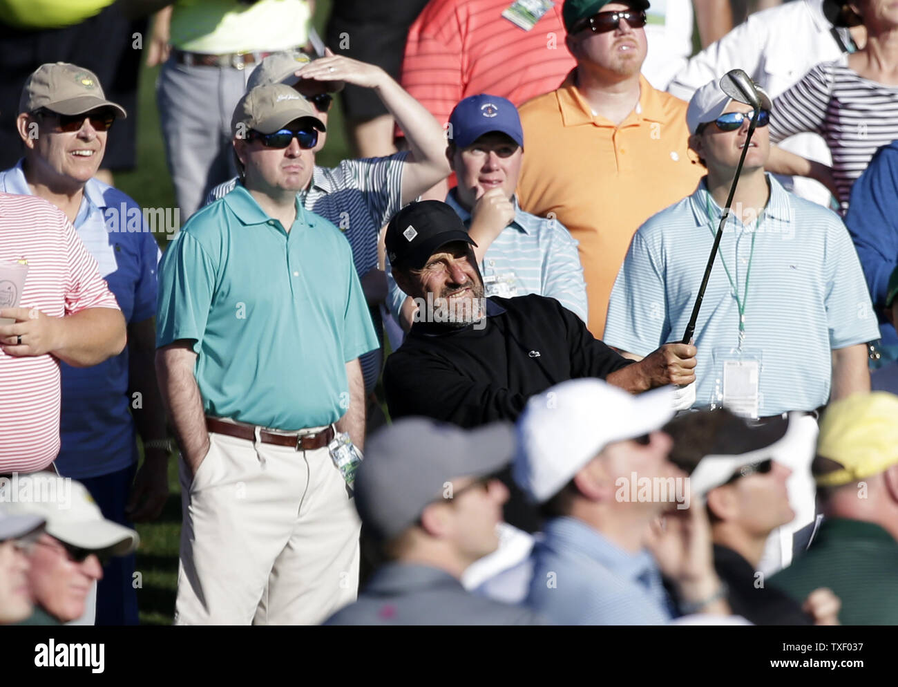 A group of patrons watch Jose Mar’a Olazabal of Spain hit a wedge to a ...