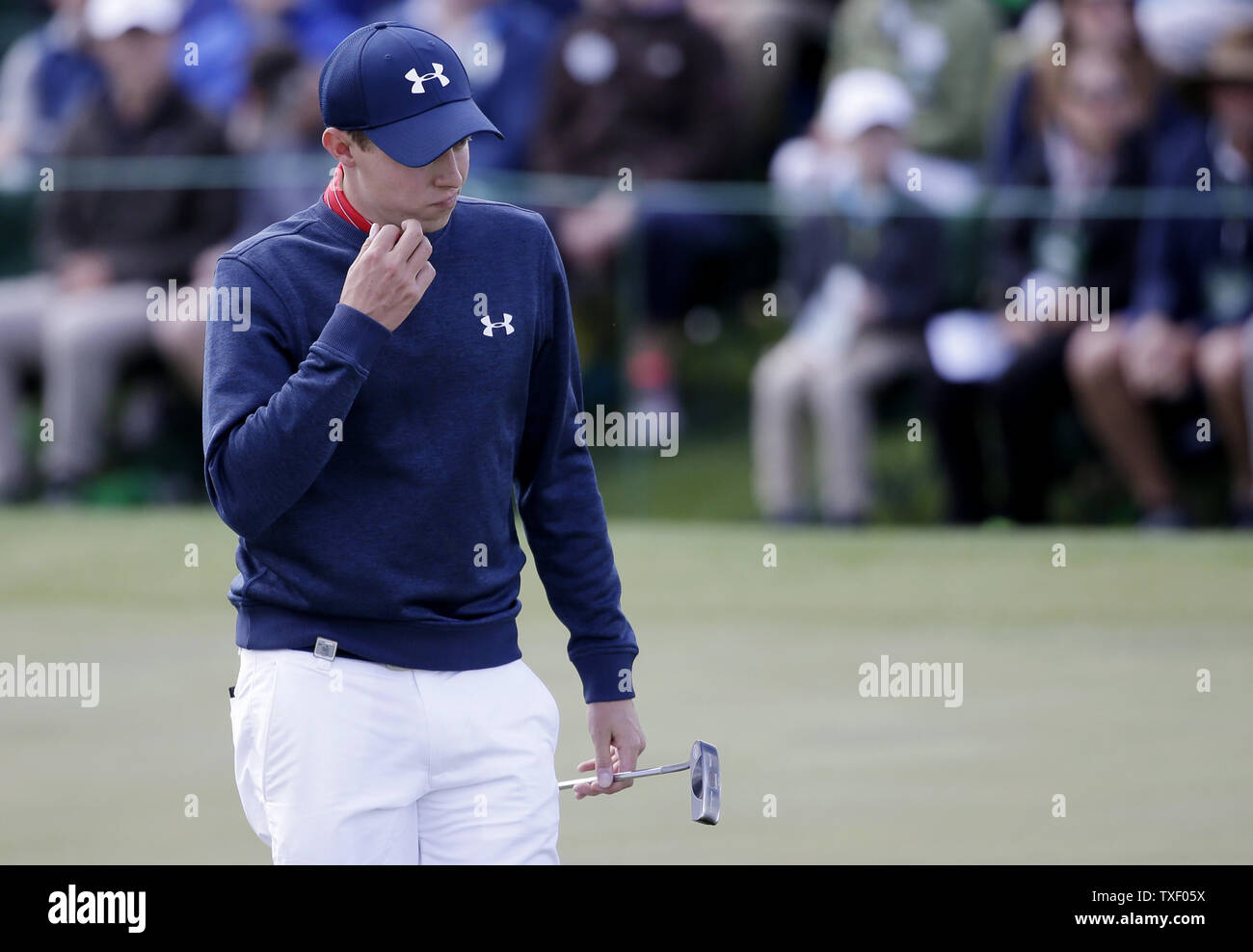Matthew Fitzpatrick of England scratches his face as he walks on the ...
