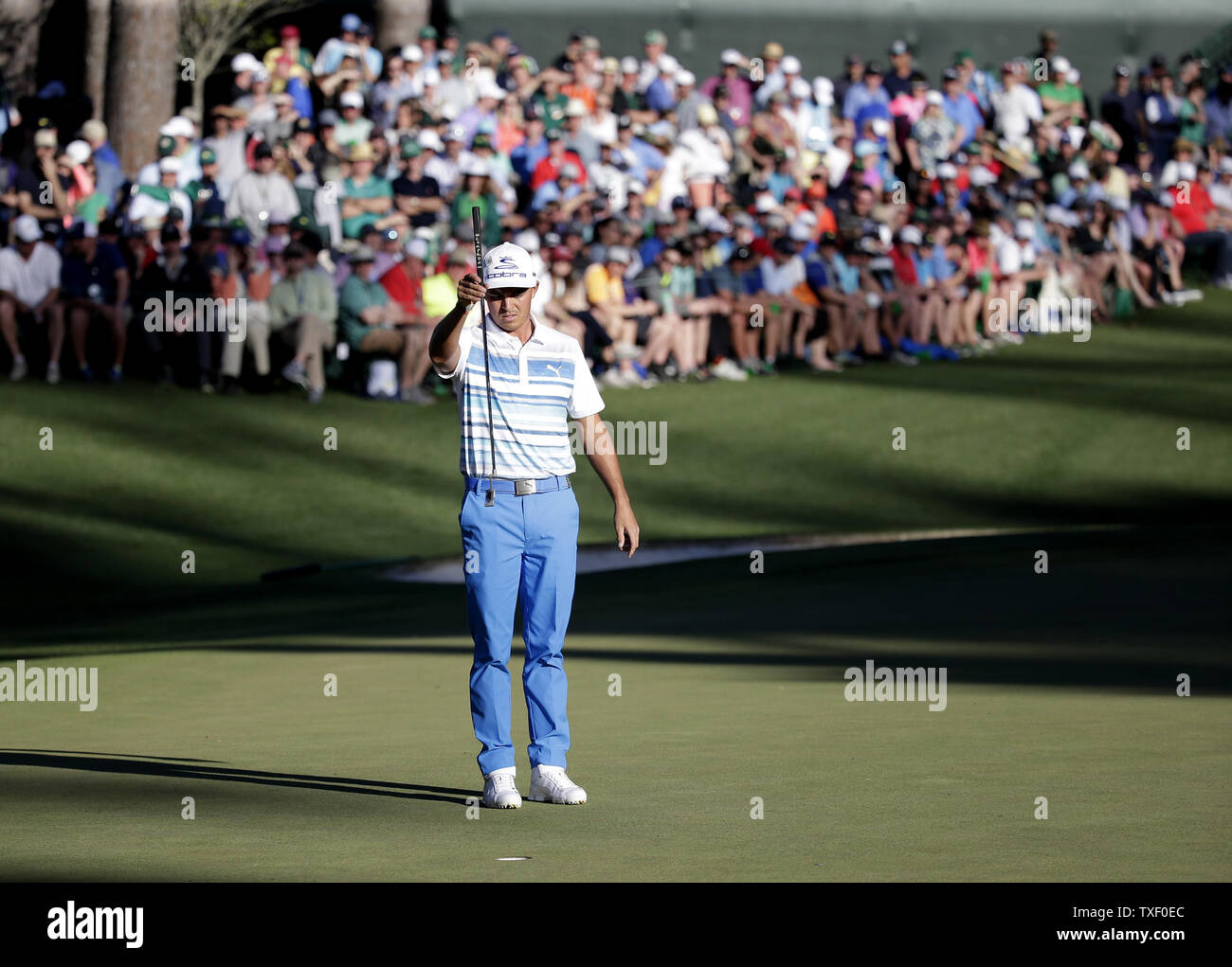 Rickie Fowler lines up a putt on the 16th hole in the third round at ...