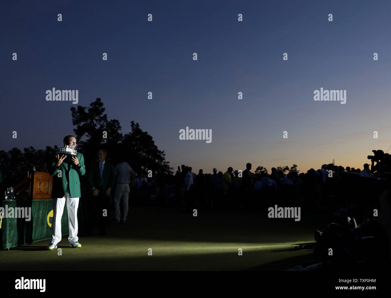 Sergio Garcia of Spain holds the Masters Trophy and wears his Green ...