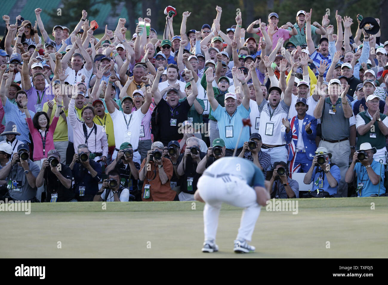 Patrons react while Sergio Garcia of Spain celebrates on the 18th green ...
