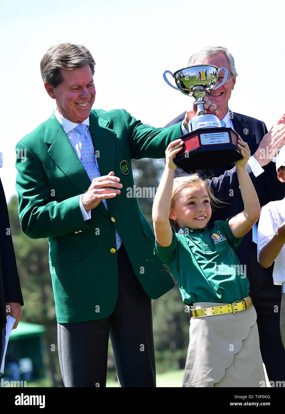 Augusta National Chairman Fred Ridley (L) helps Ella June Hannant hold ...