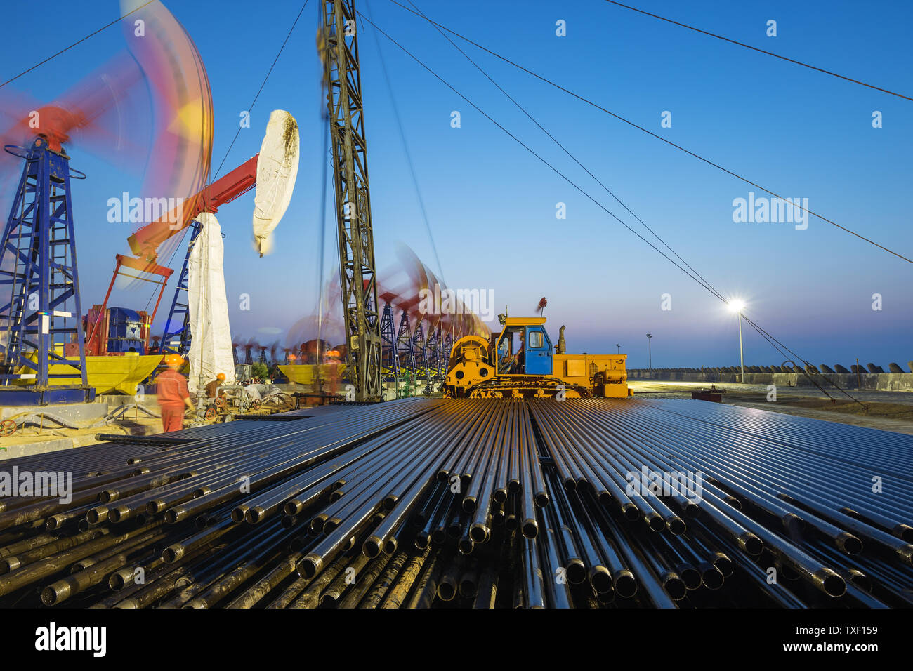 working oil-rig of oilfield day and night Stock Photo - Alamy