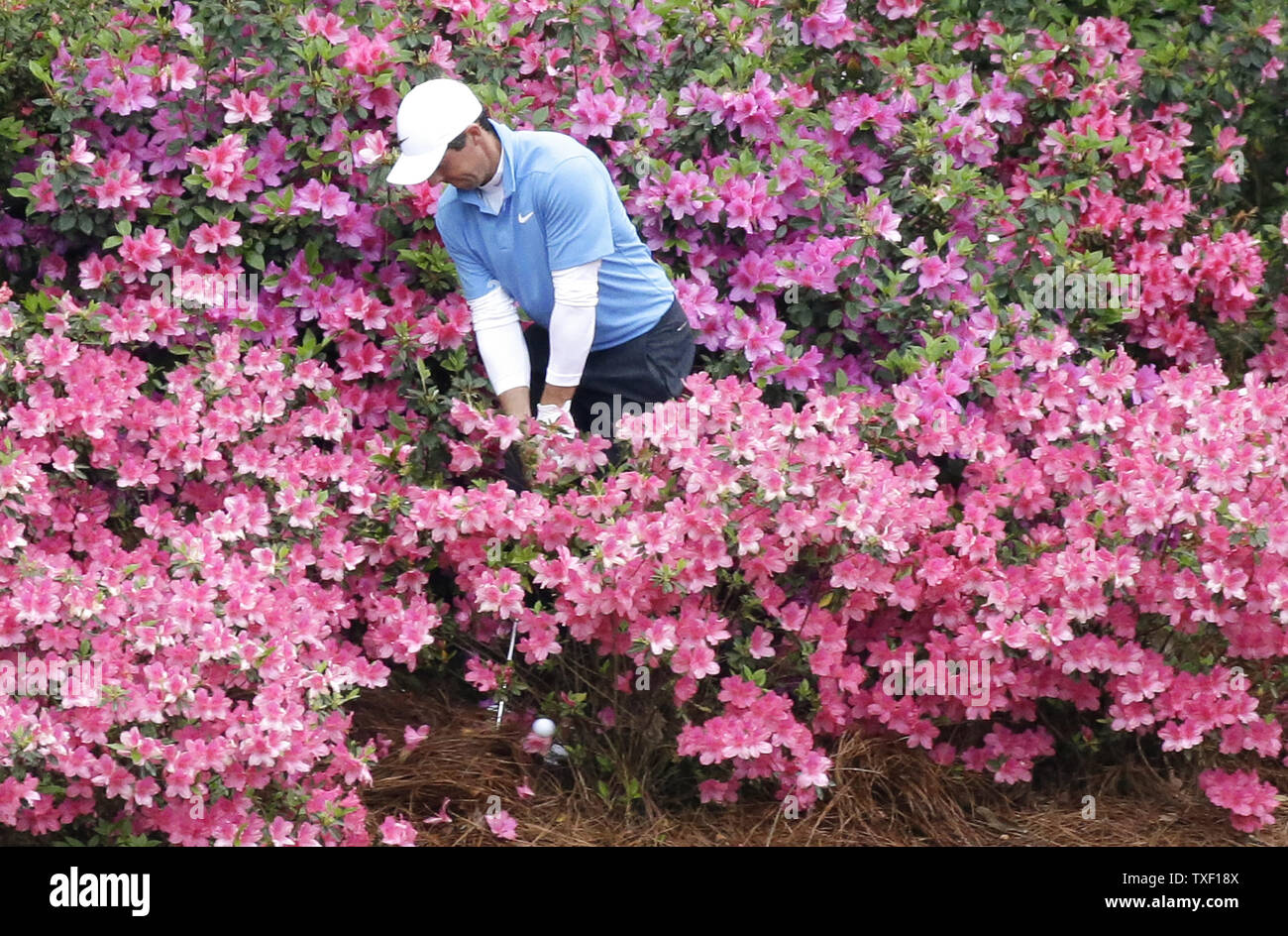 Rory McIlroy of Northern Ireland hits his golf ball out of a pack of ...