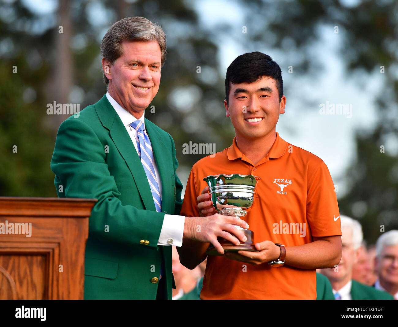 Augusta National Chairman Fred Ridley presents Doug Ghim with the low ...
