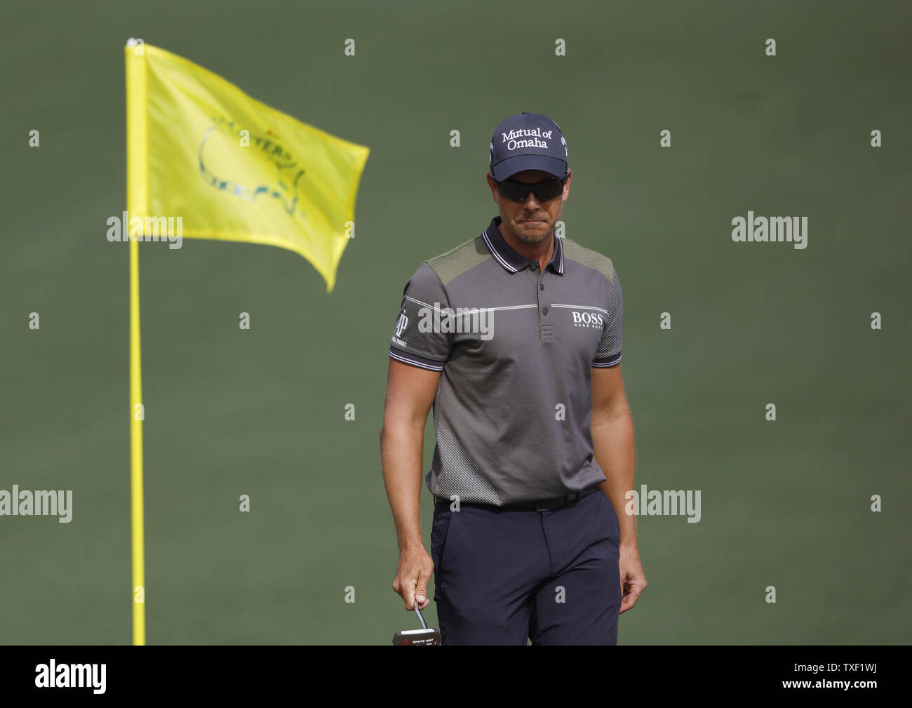 Henrik Stenson of Sweeden walks on the 2nd green in the first round at ...